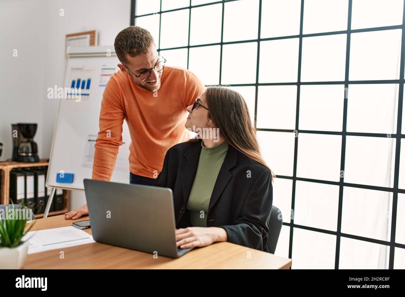 Two caucasian business executives working at the office Stock Photo - Alamy