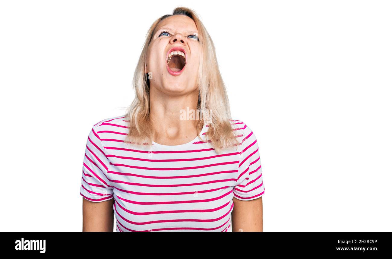 Young caucasian woman wearing casual clothes angry and mad screaming ...