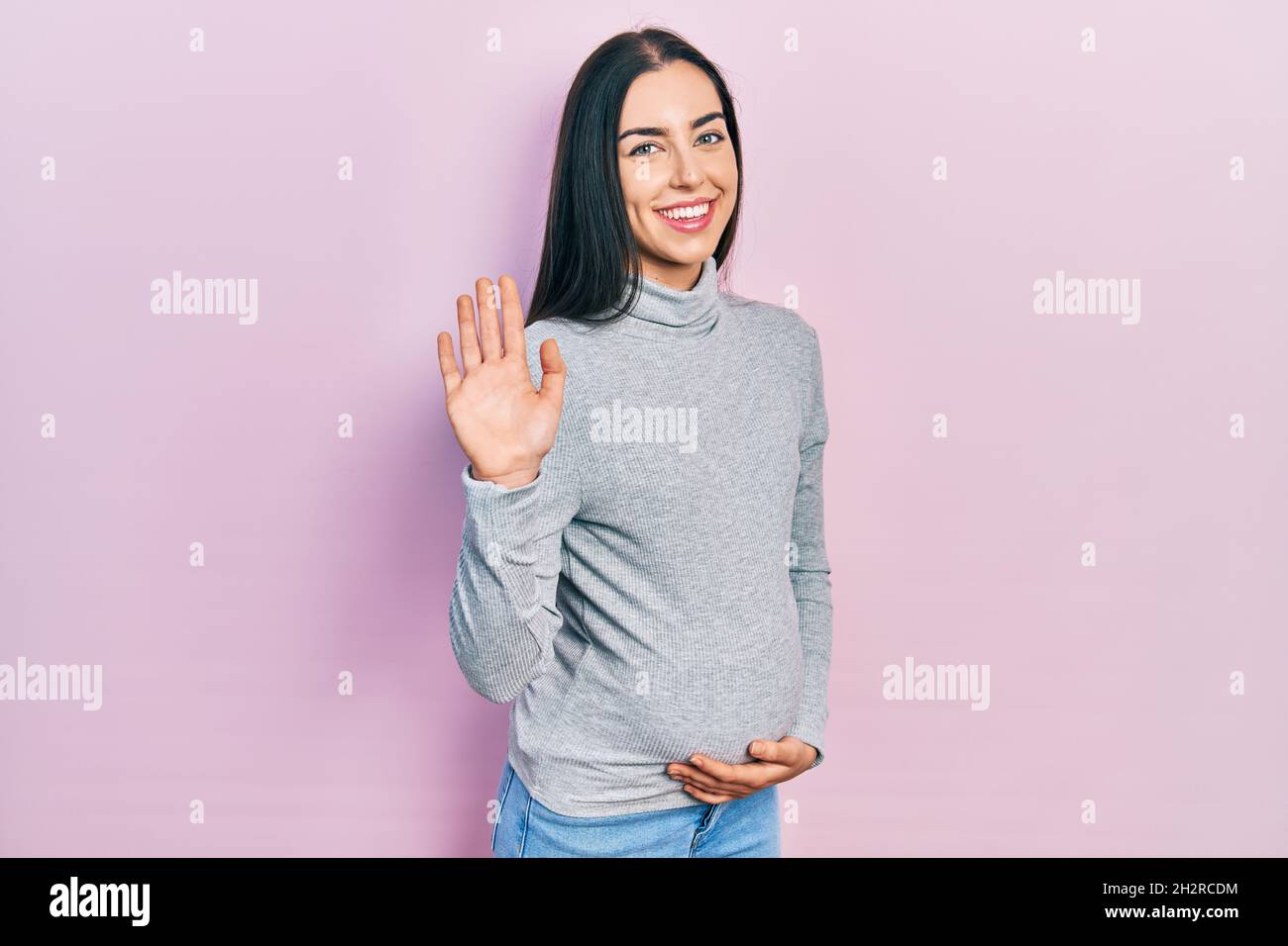 Beautiful woman with blue eyes expecting a baby, touching pregnant ...