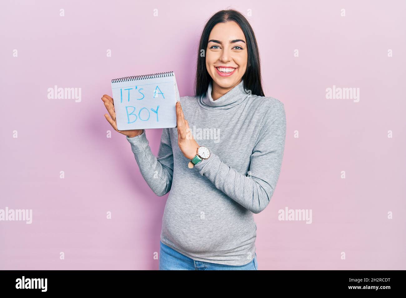 Beautiful woman with blue eyes expecting a baby holding its a boy ...