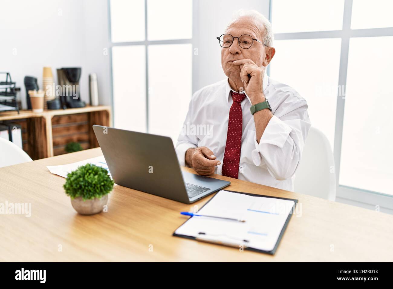 Senior man working at the office using computer laptop mouth and lips ...