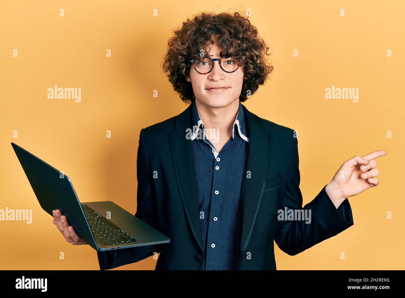 Handsome young man working using computer laptop smiling happy pointing ...