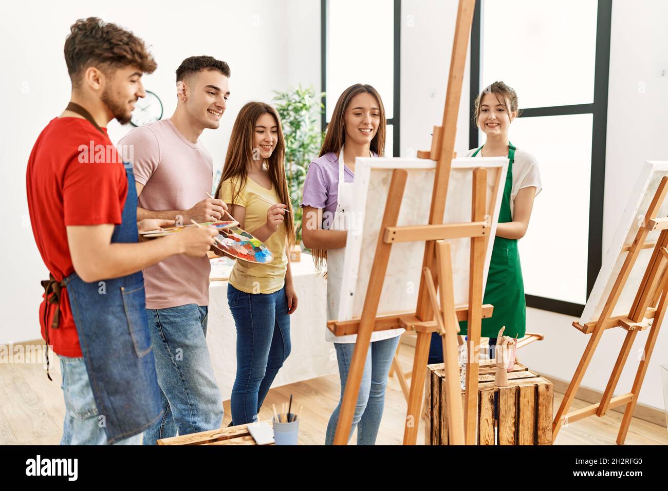 Group of people smiling happy drawing on canvas standing at art studio ...