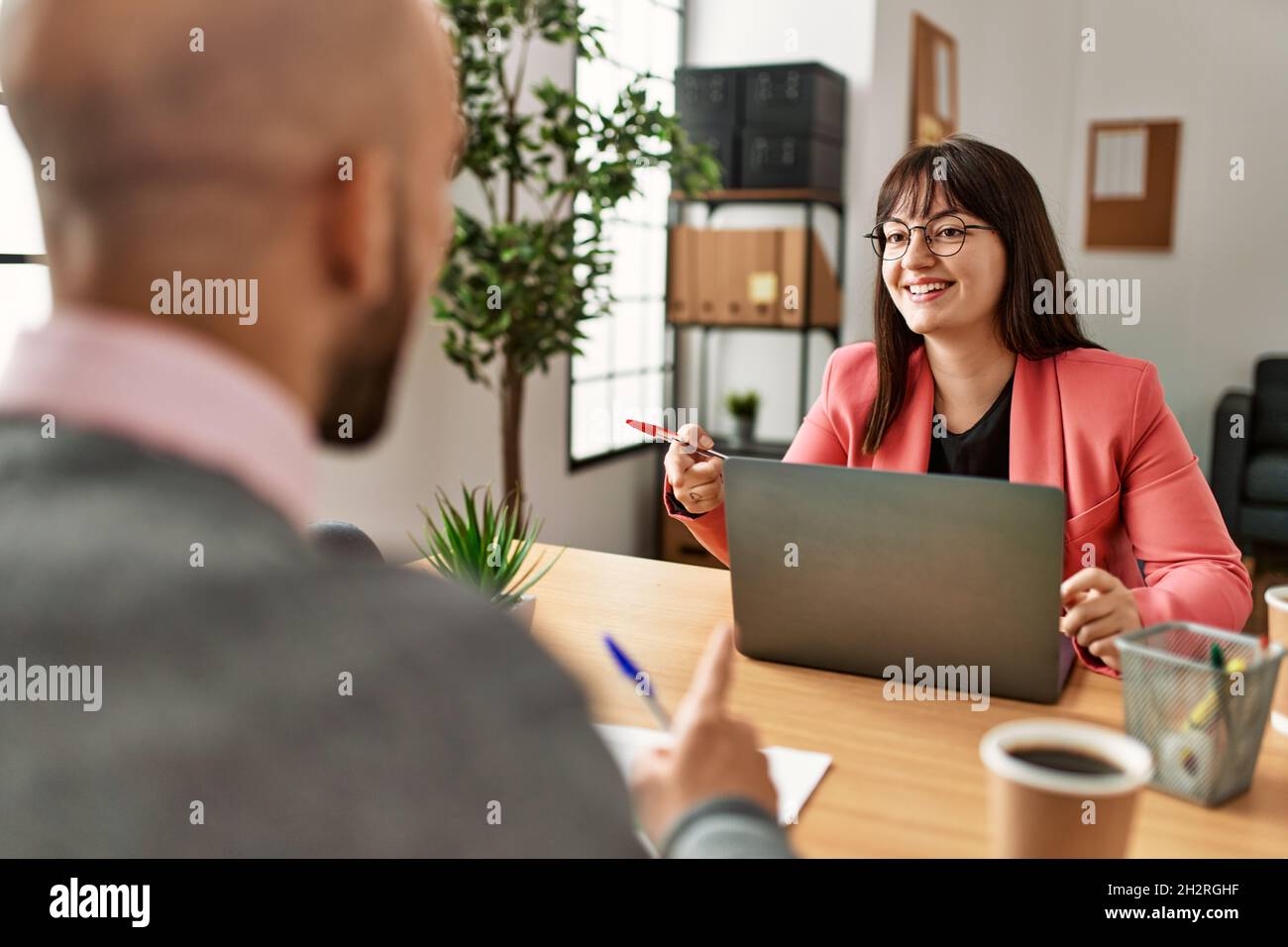 Two hispanic business workers smiling happy working at the office Stock ...