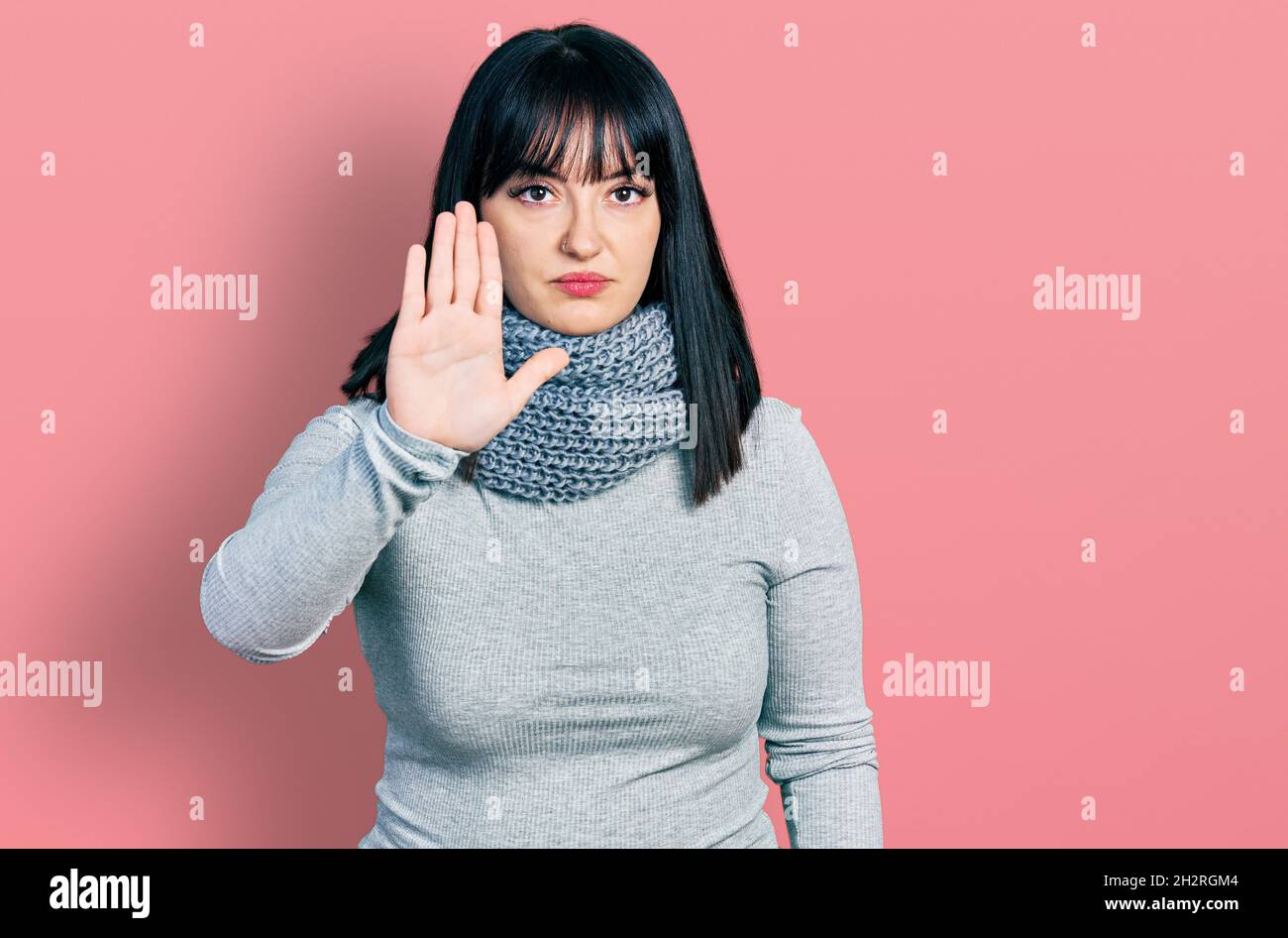 Young hispanic plus size woman wearing winter scarf doing stop sing ...