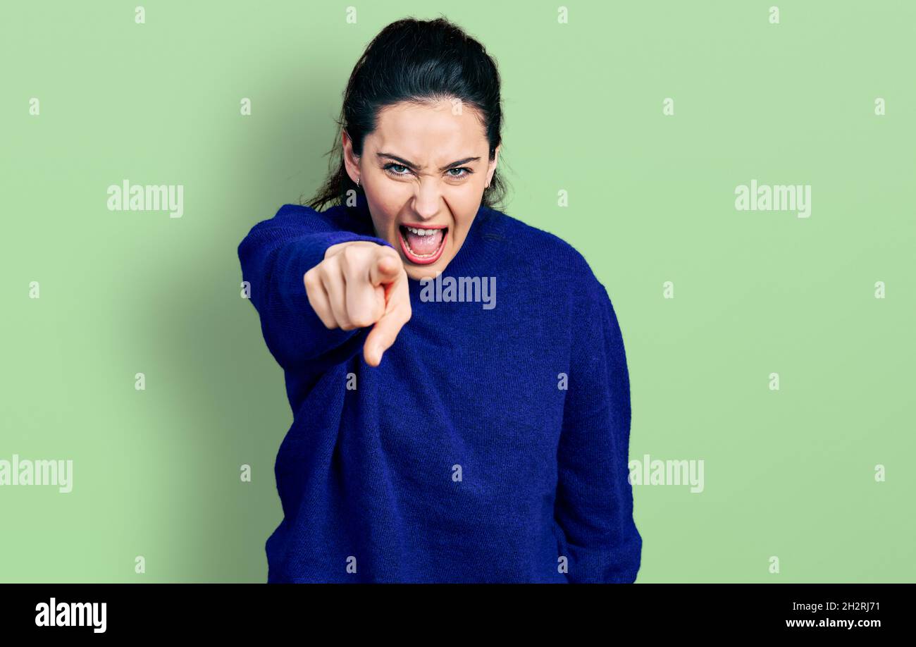 Young Hispanic Woman Wearing Casual Clothes Pointing Displeased And