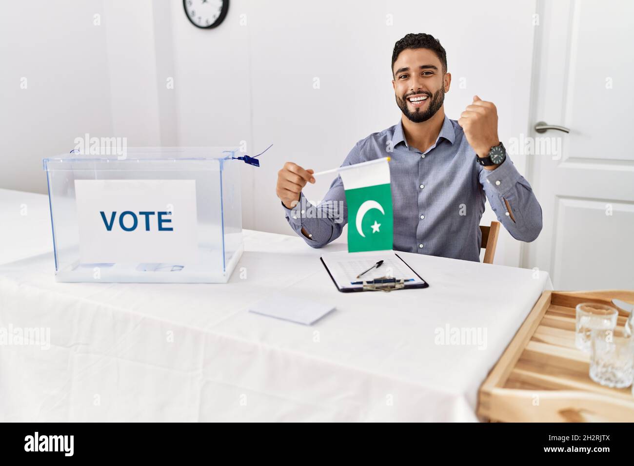 Young handsome man with beard at political campaign election holding ...