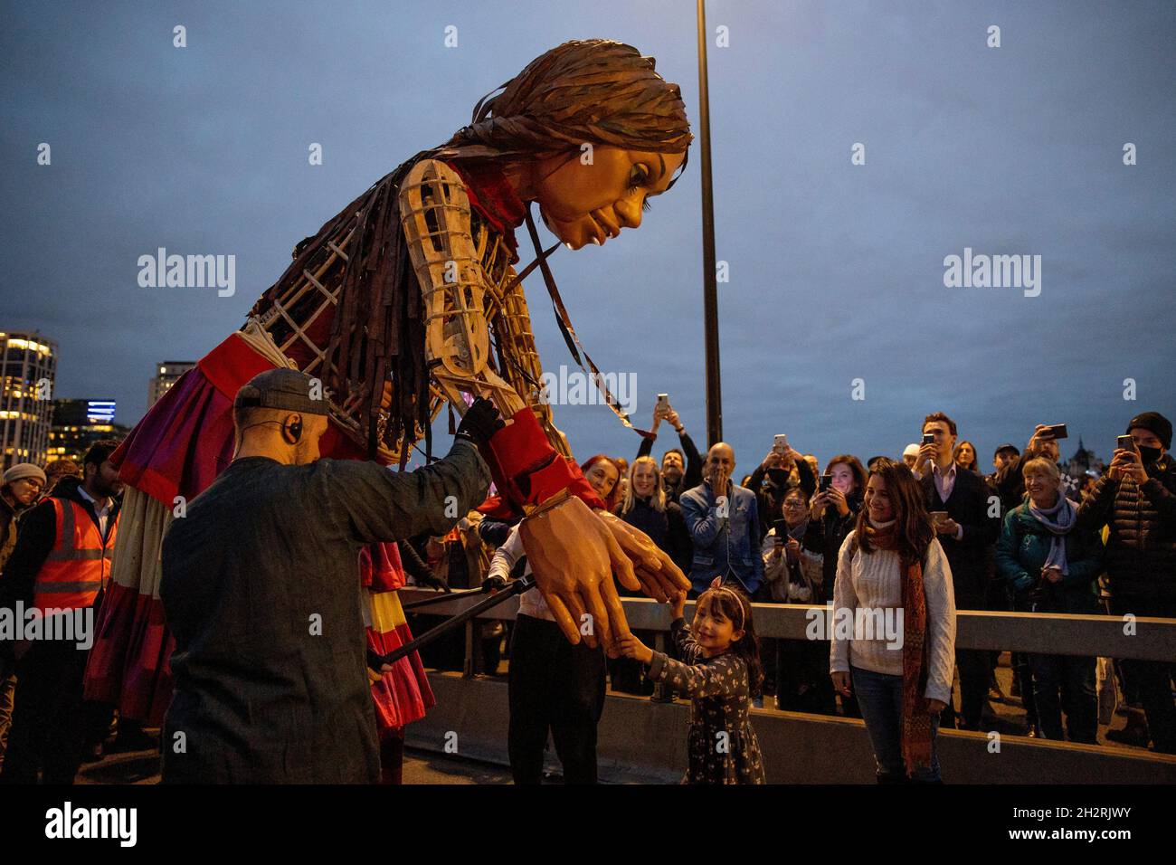 London, UK. 23rd Oct, 2021. Little Amal seen interacting with a child ...