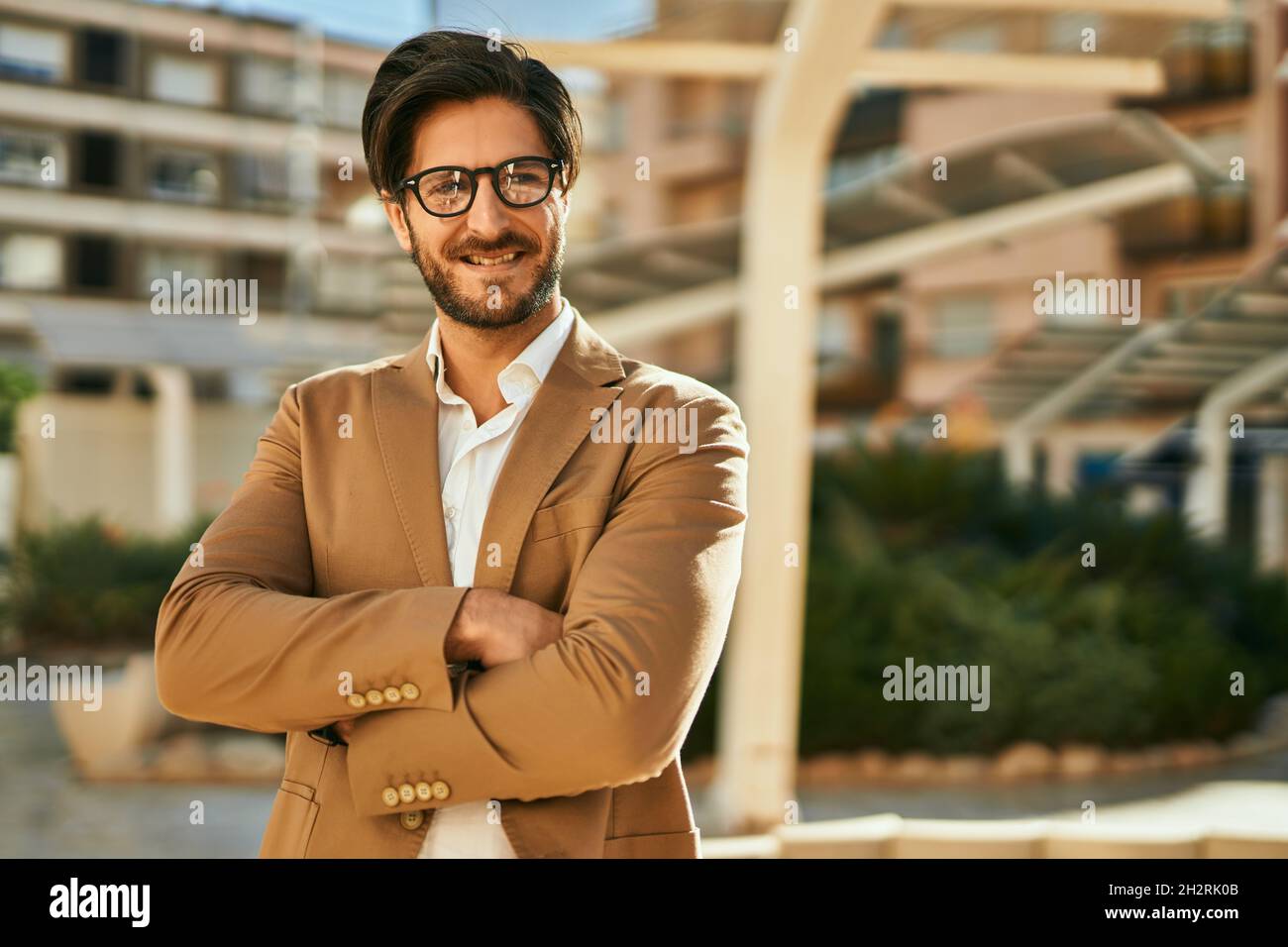 Young hispanic businessman smiling happy standing at the city Stock ...