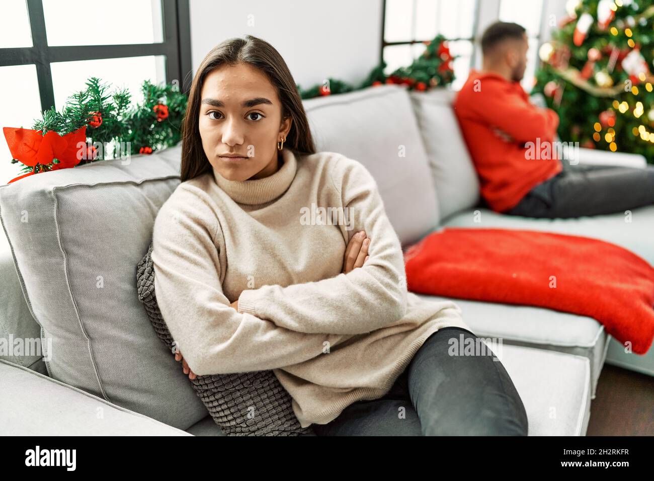 Young Hispanic Couple On Problems With Sad Expression Sitting On The