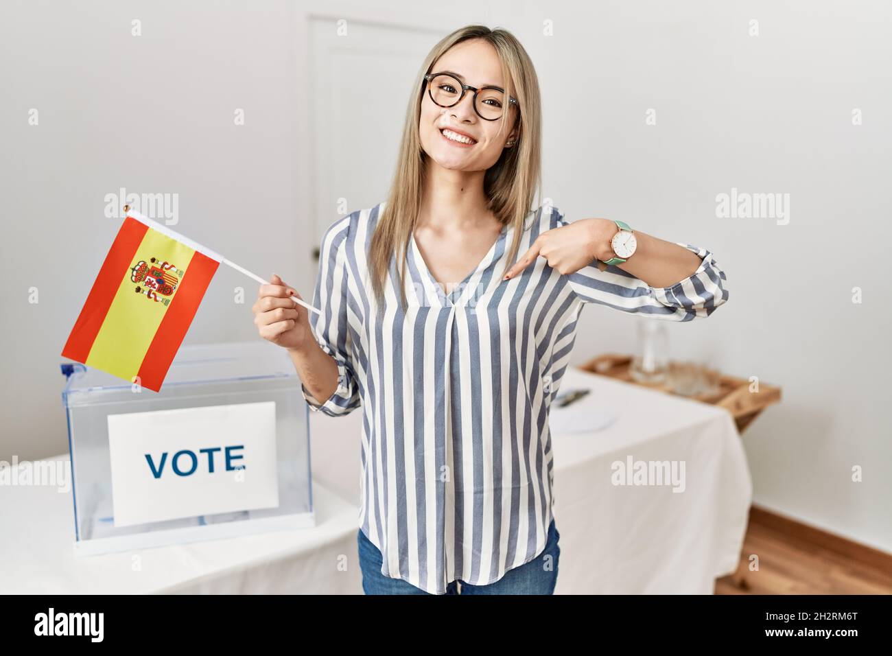Asian young woman at political campaign election holding spain flag ...