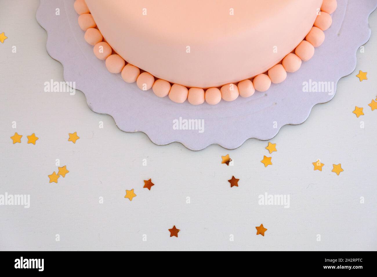 A top view of a pink cake with star shaped confetti aroun Stock Photo ...