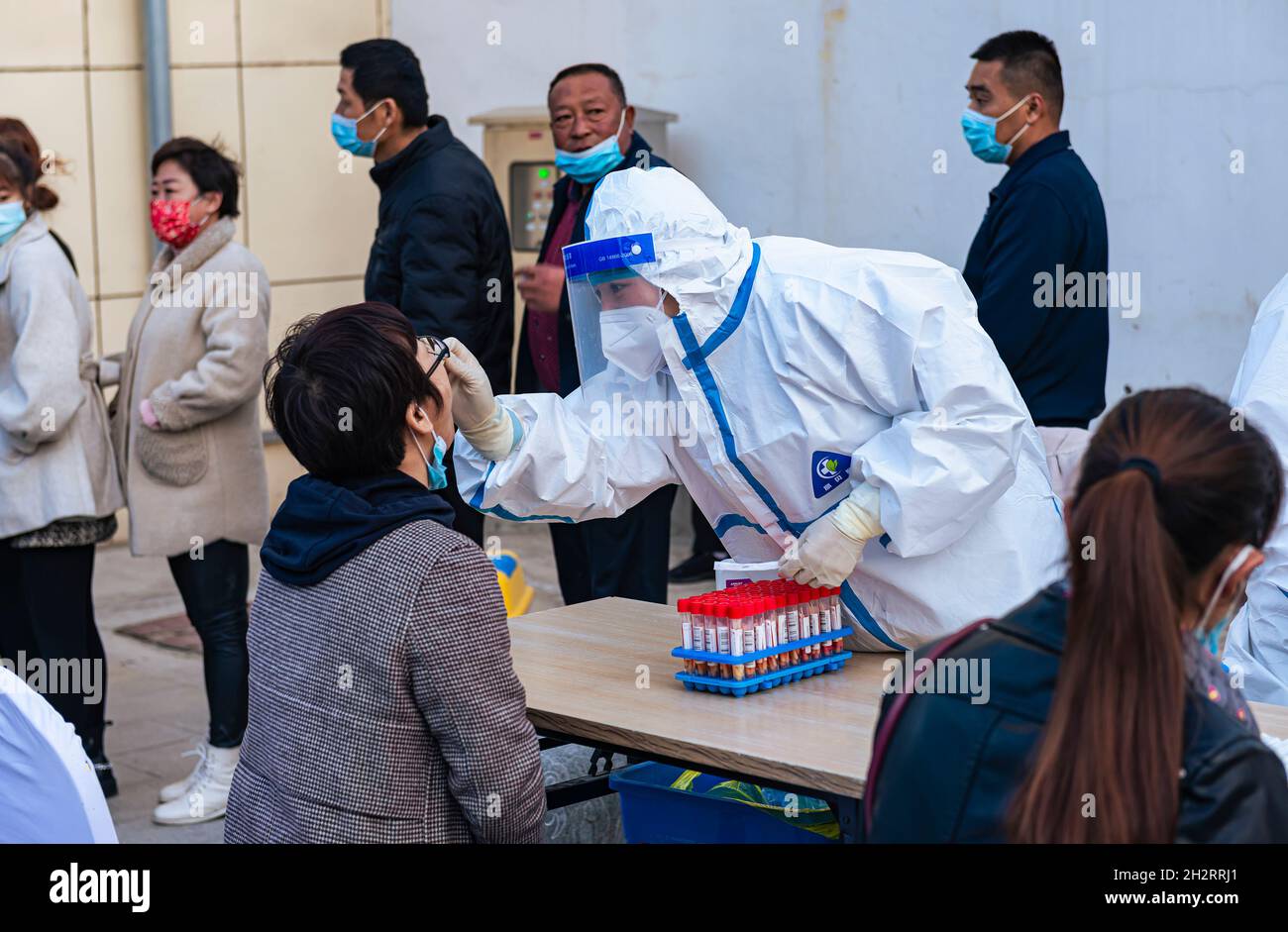 JIUQUAN, CHINA - OCTOBER 22, 2021 - A medical worker takes nucleic acid ...