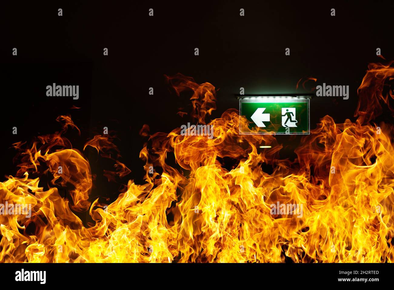 Green fire escape sign hang on the ceiling in the Warehouse. The ...