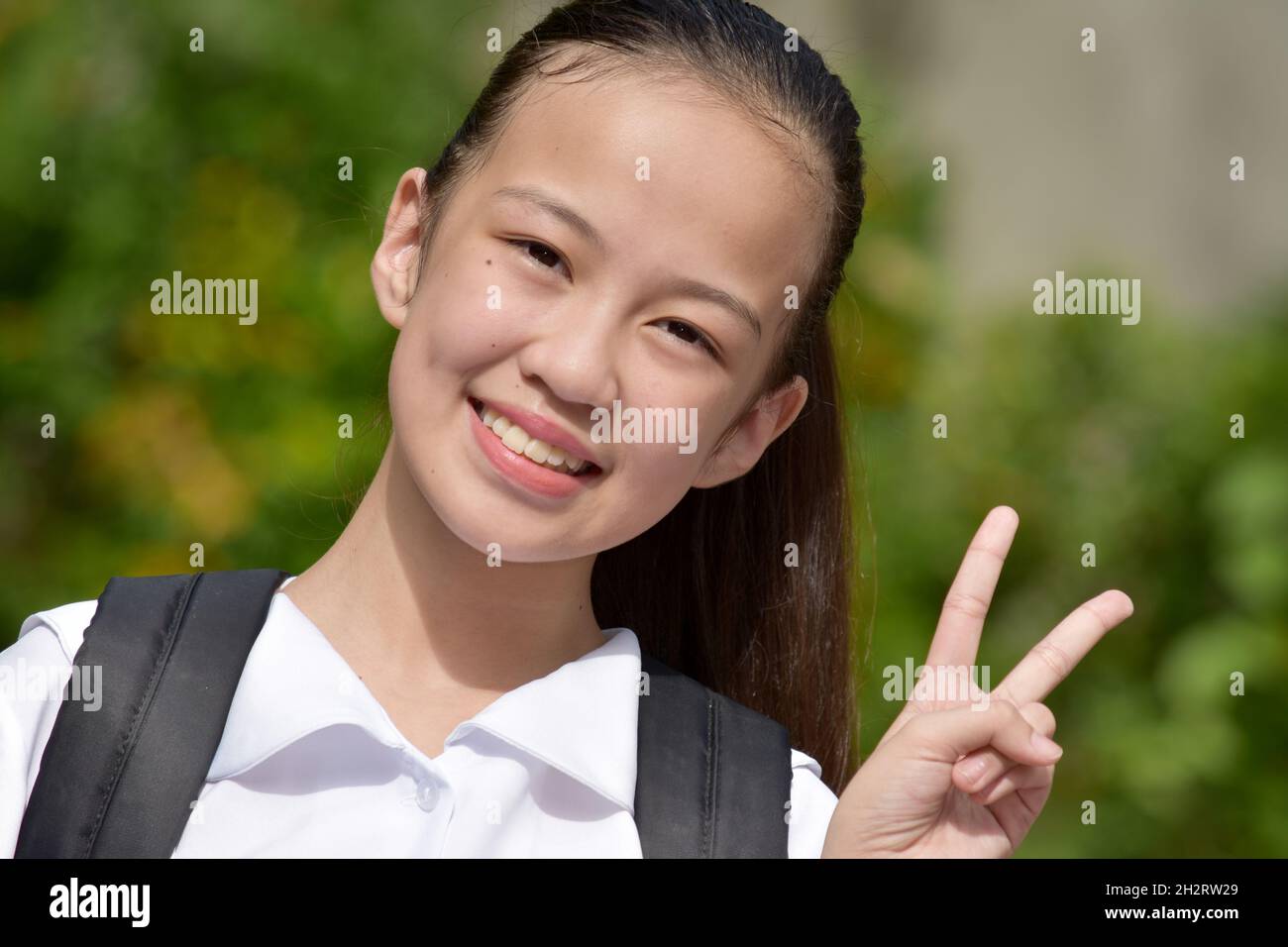 A School Girl And Peace Sign Stock Photo - Alamy