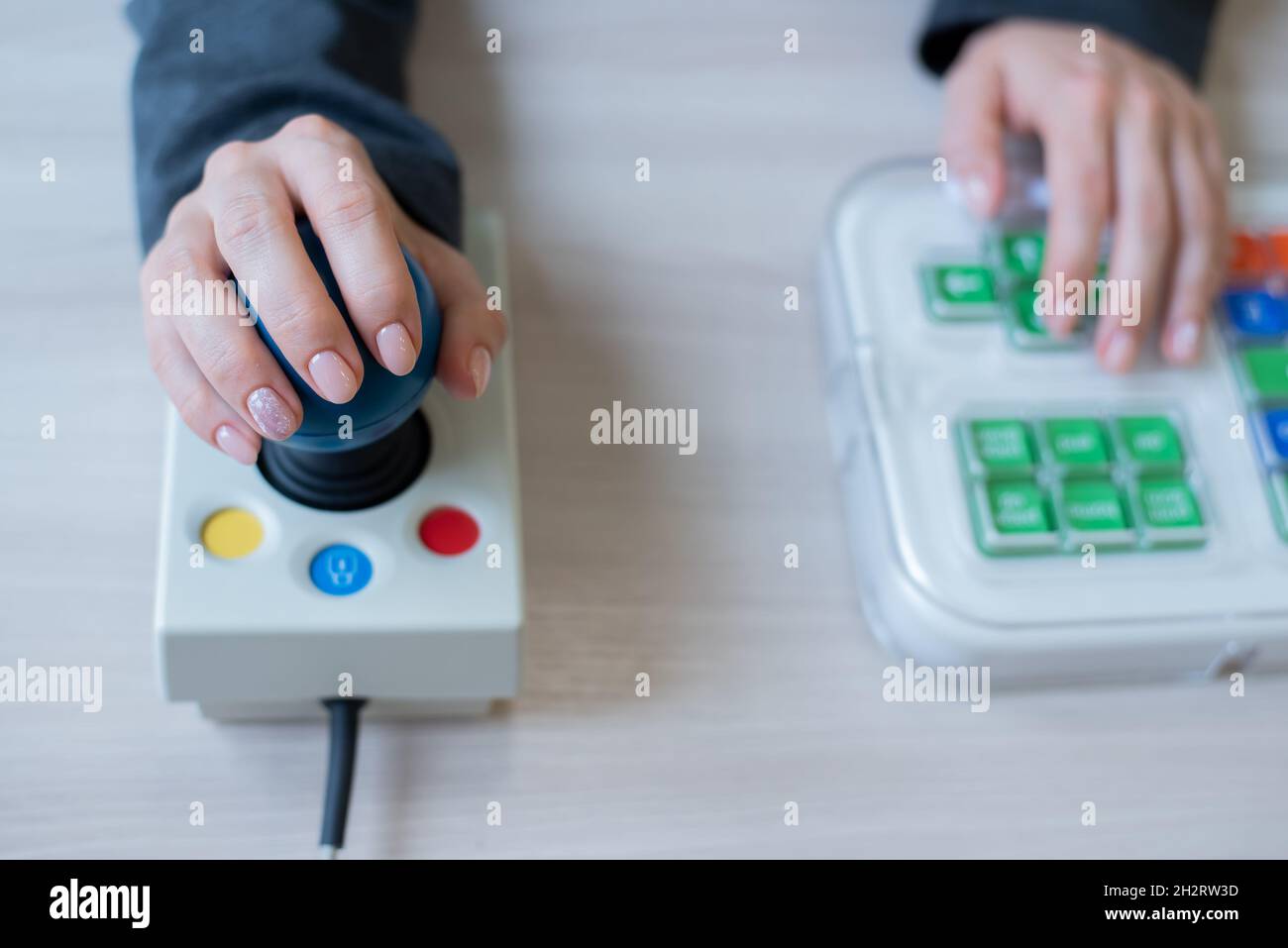 Woman with cerebral palsy works on a specialized computer mouse Stock ...