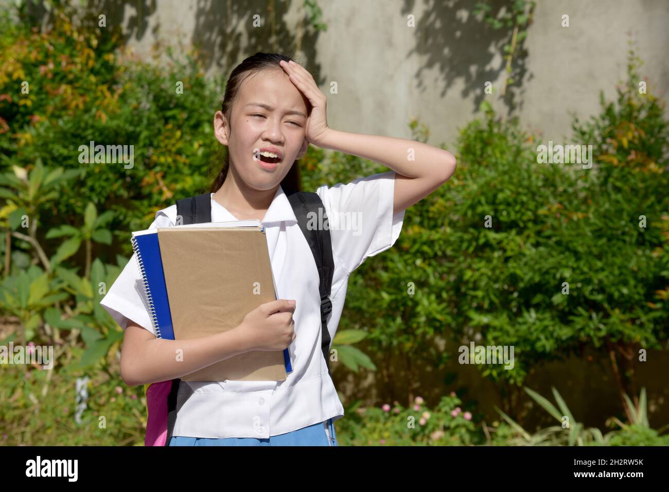 Stressed Youthful Filipina Female Student With Notebooks Stock Photo ...