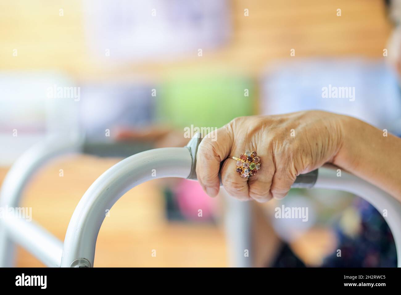 Elderly asian woman using a walker in restaurant Stock Photo - Alamy