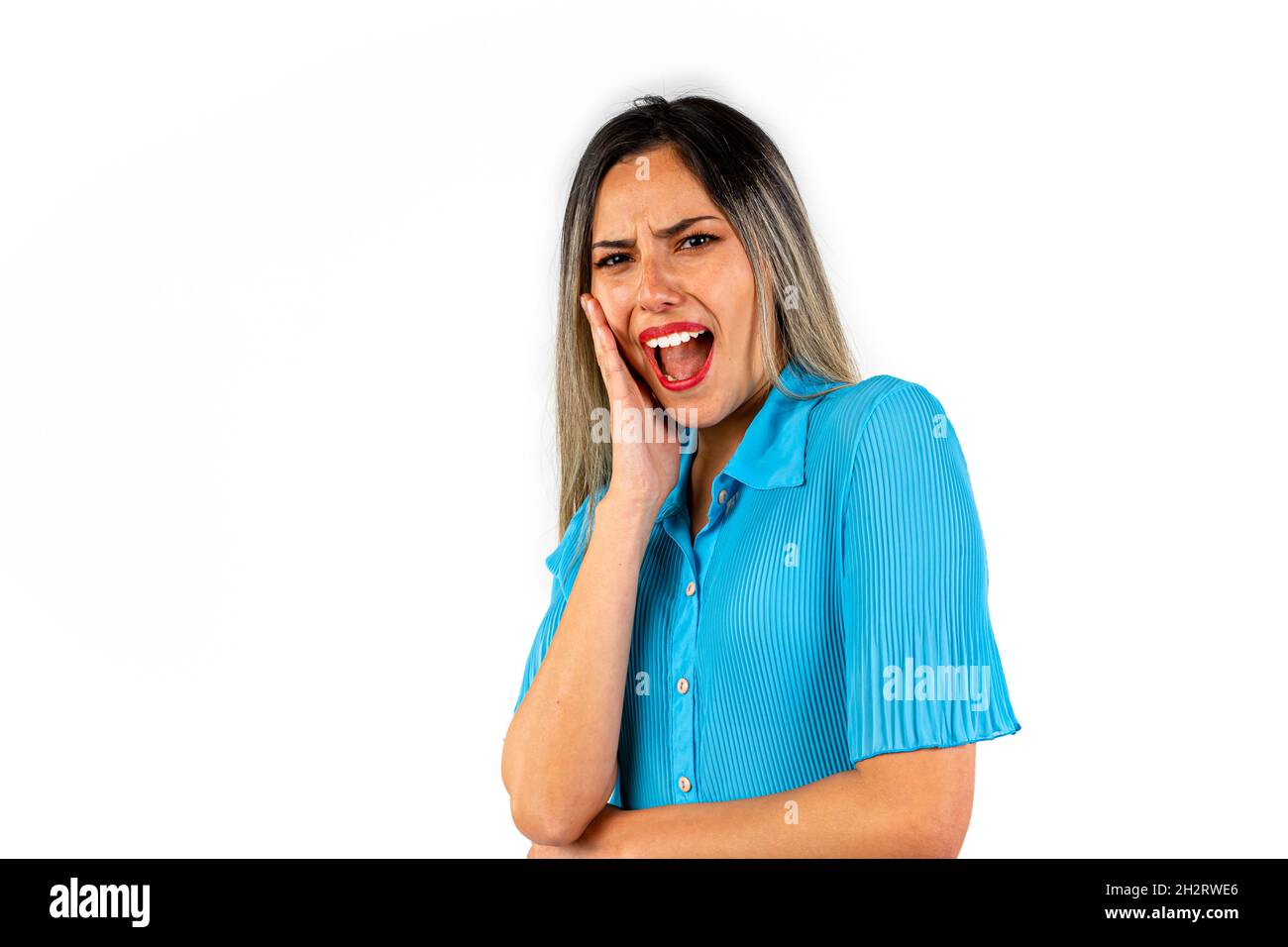 A Beautiful young woman with an expression of fear and with her hand on ...