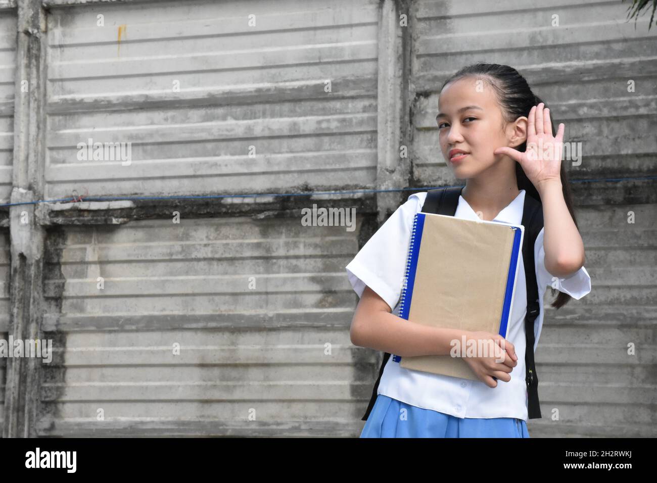 Youthful Filipina Girl Student Hearing With School Books Stock Photo ...