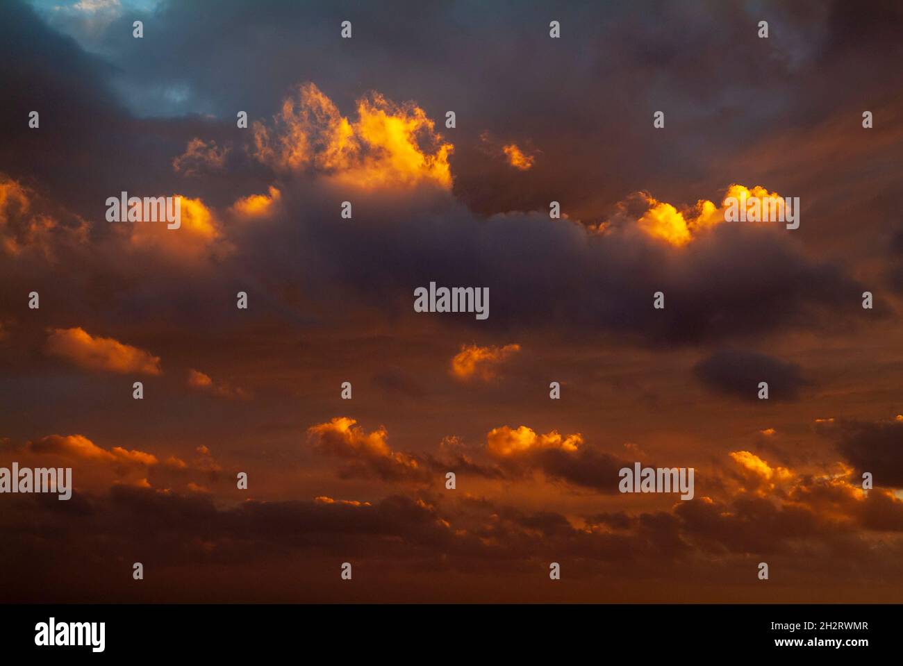 Colorful sunset sky with dramatic orange clouds. Only sky, no land ...