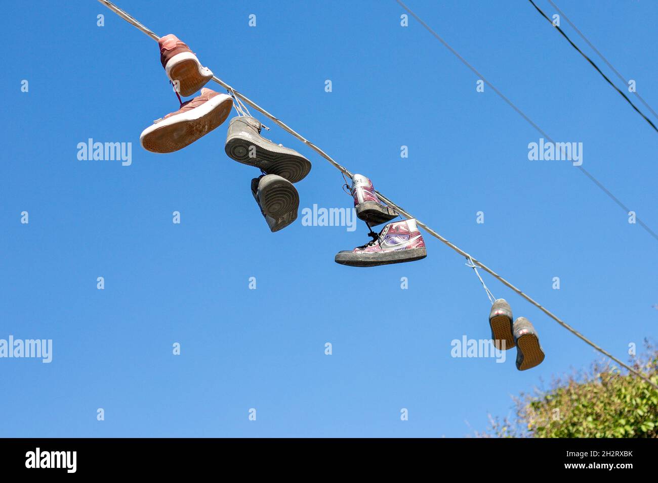 Shoes hanging from wires Stock Photo - Alamy