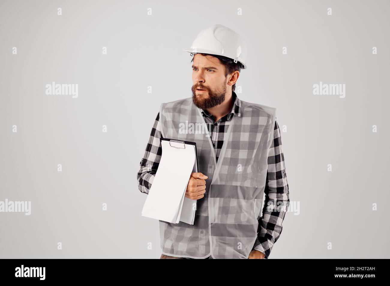 male builder with documents and drawings blueprints isolated background ...