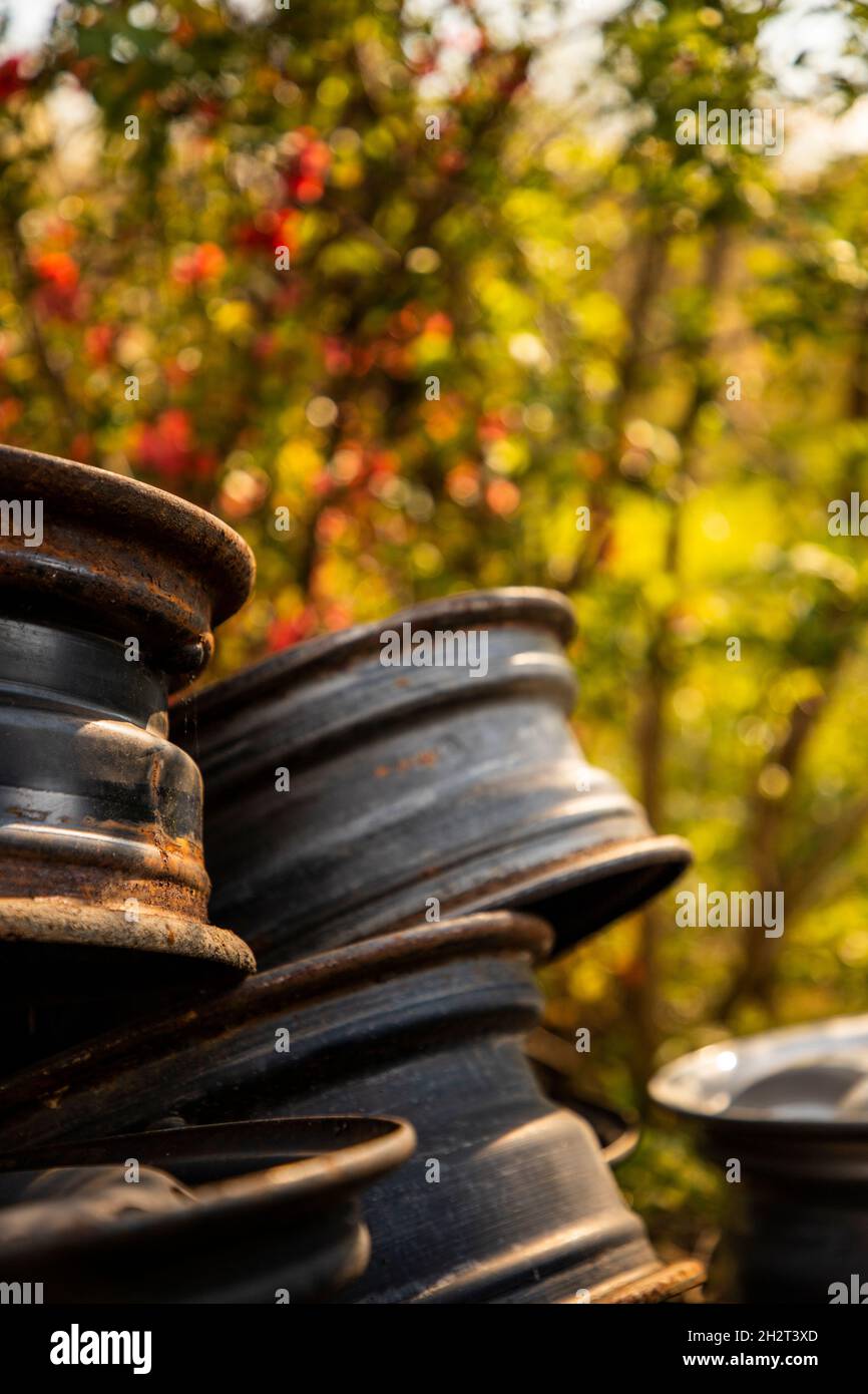 Pile of old steal rims thrown away into nature Stock Photo - Alamy