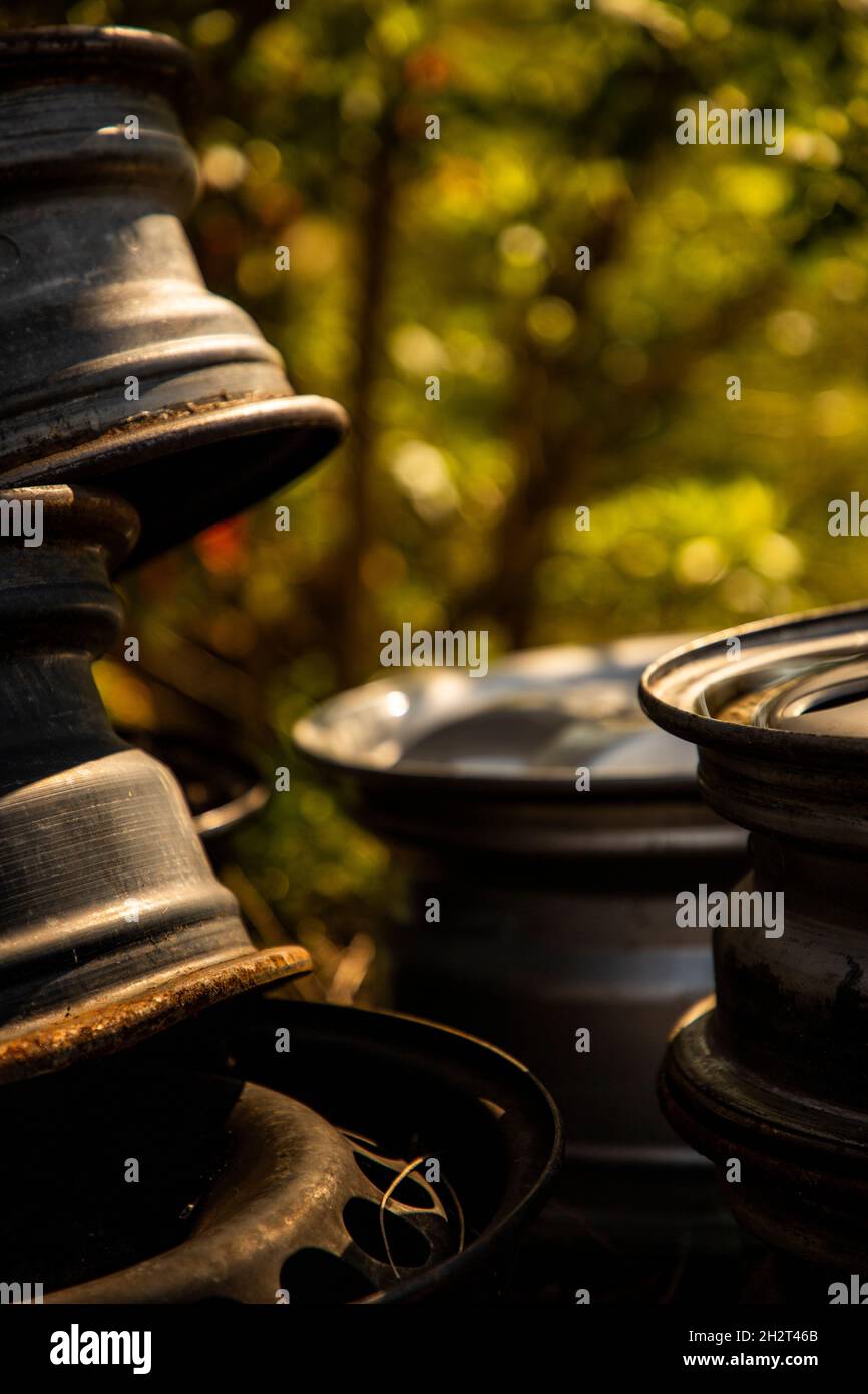Pile of old steal rims thrown away into nature Stock Photo - Alamy