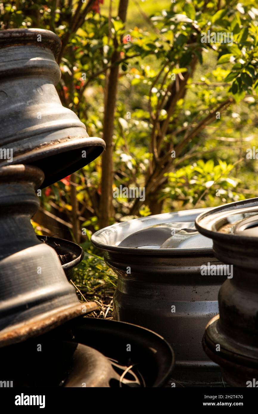 Pile of old steal rims thrown away into nature Stock Photo - Alamy