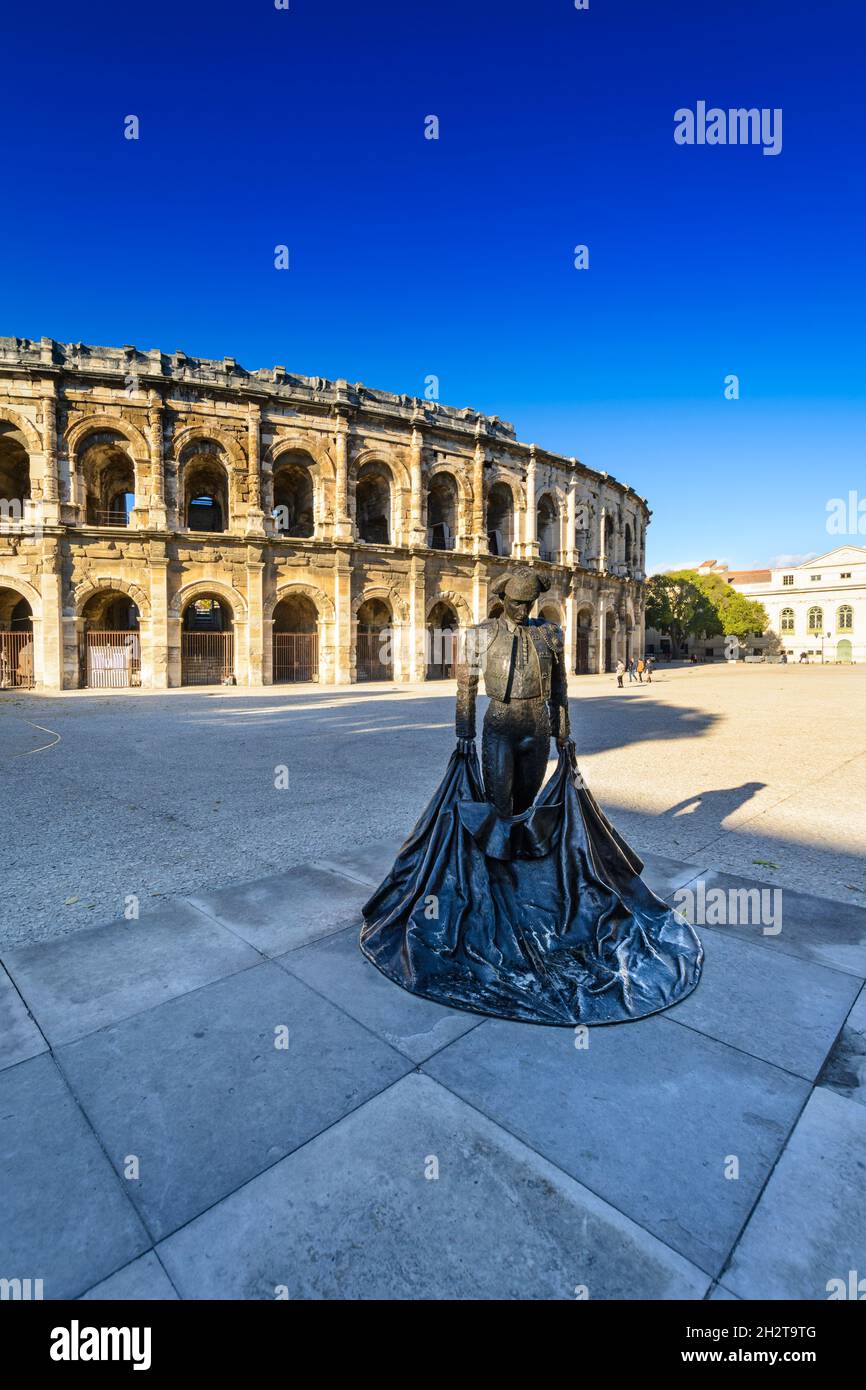 Arena of Nimes and statue in France Stock Photo - Alamy
