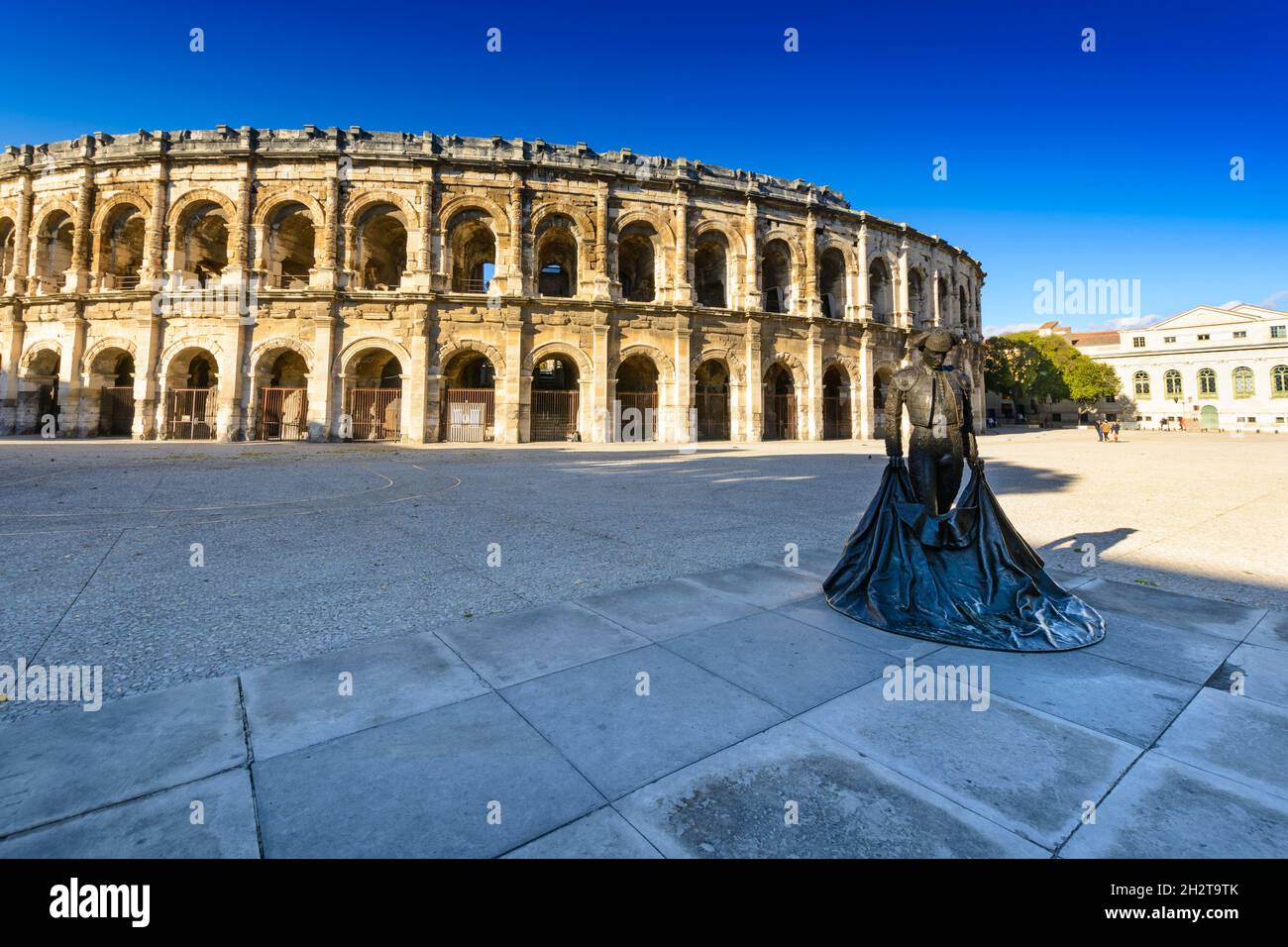 Arena of Nimes and statue in France Stock Photo - Alamy