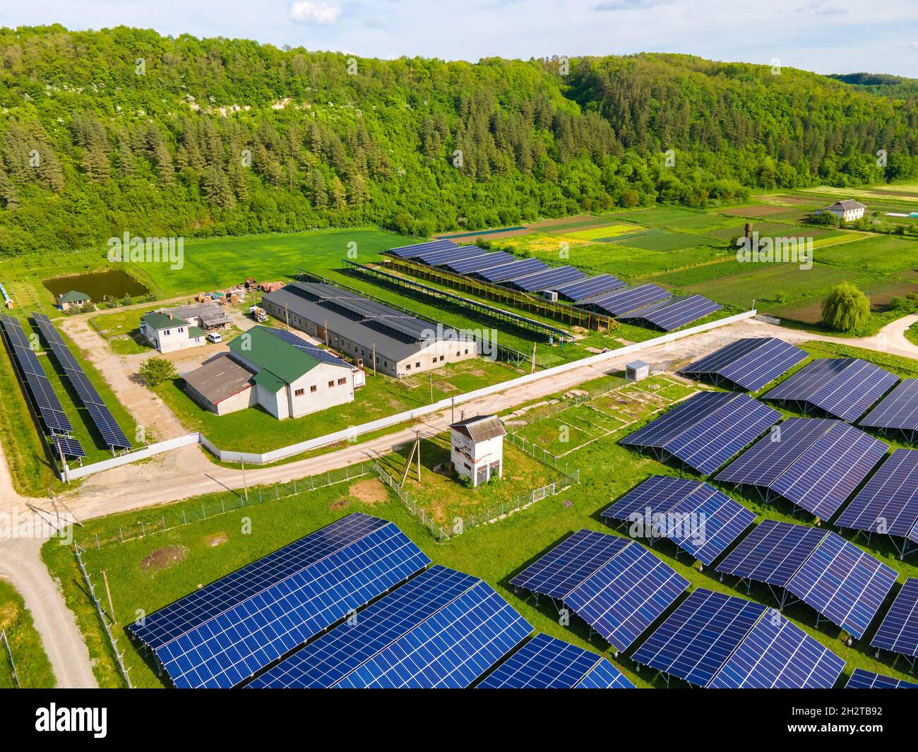 Aerial view of large sustainable electrical power plant with rows of ...