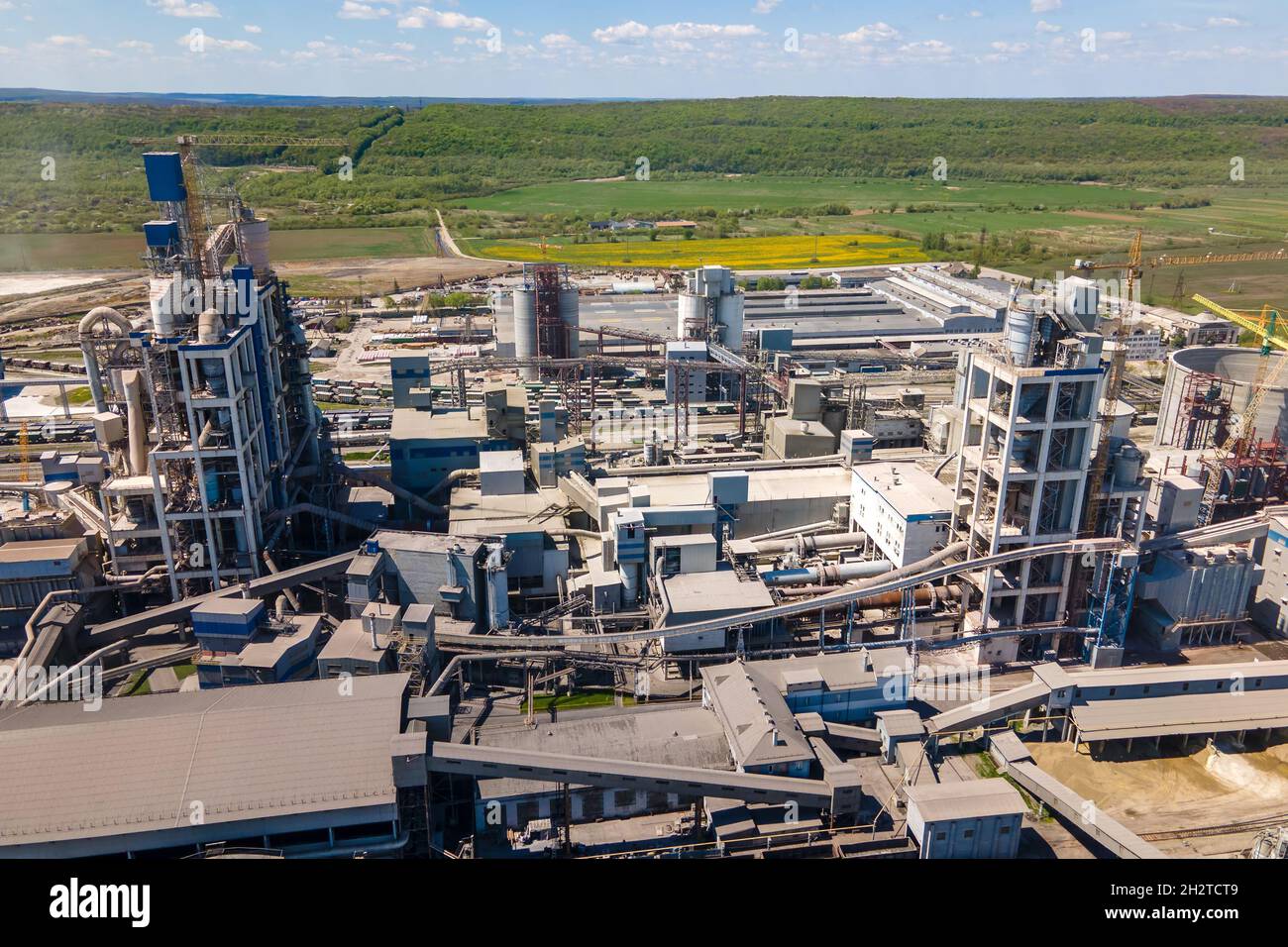 Aerial view of cement factory with high concrete structure and tower ...