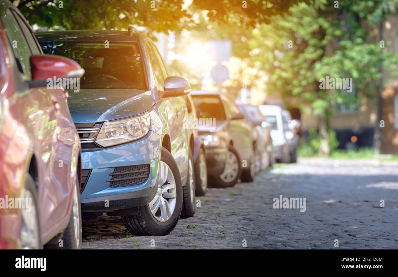 City traffic with cars parked in line on street side Stock Photo - Alamy