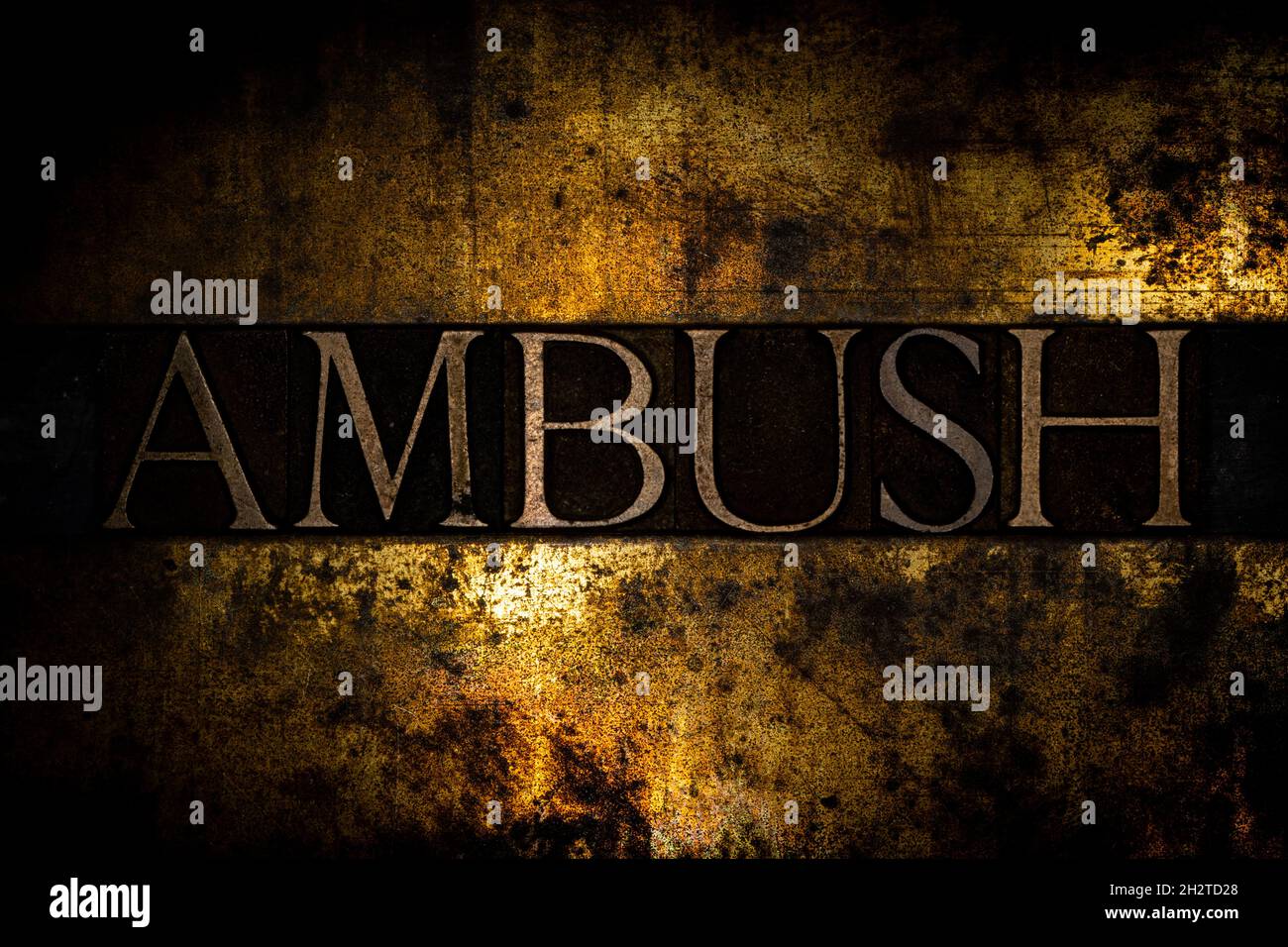 Ambush text on grunge textured gold and copper background Stock Photo ...