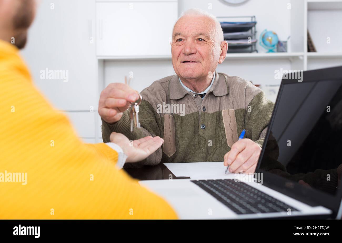 Man selling house in office Stock Photo - Alamy