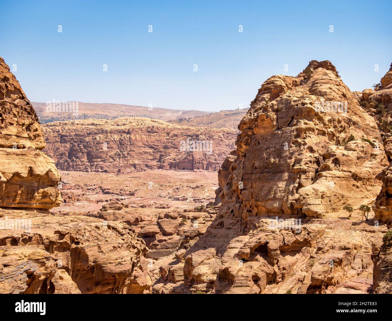Mountain wall of red sand rock that surround the ancient city of Petra ...
