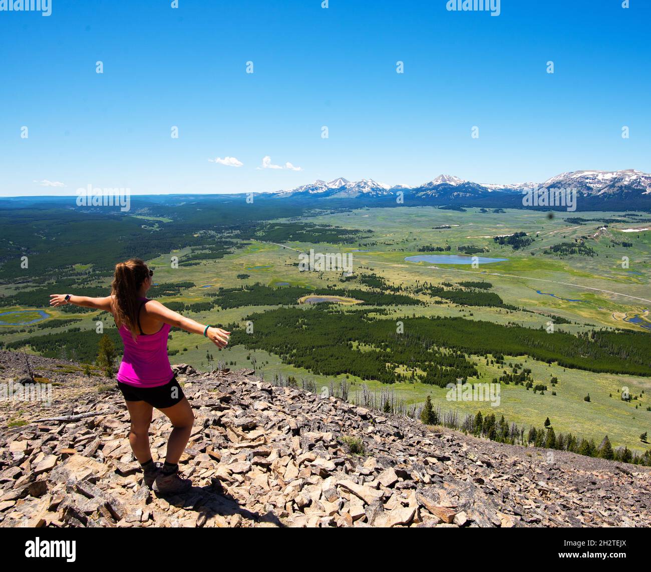 A rear view of a woman hiker resting in Yellowstone National Park, USA Stock Photo - Alamy