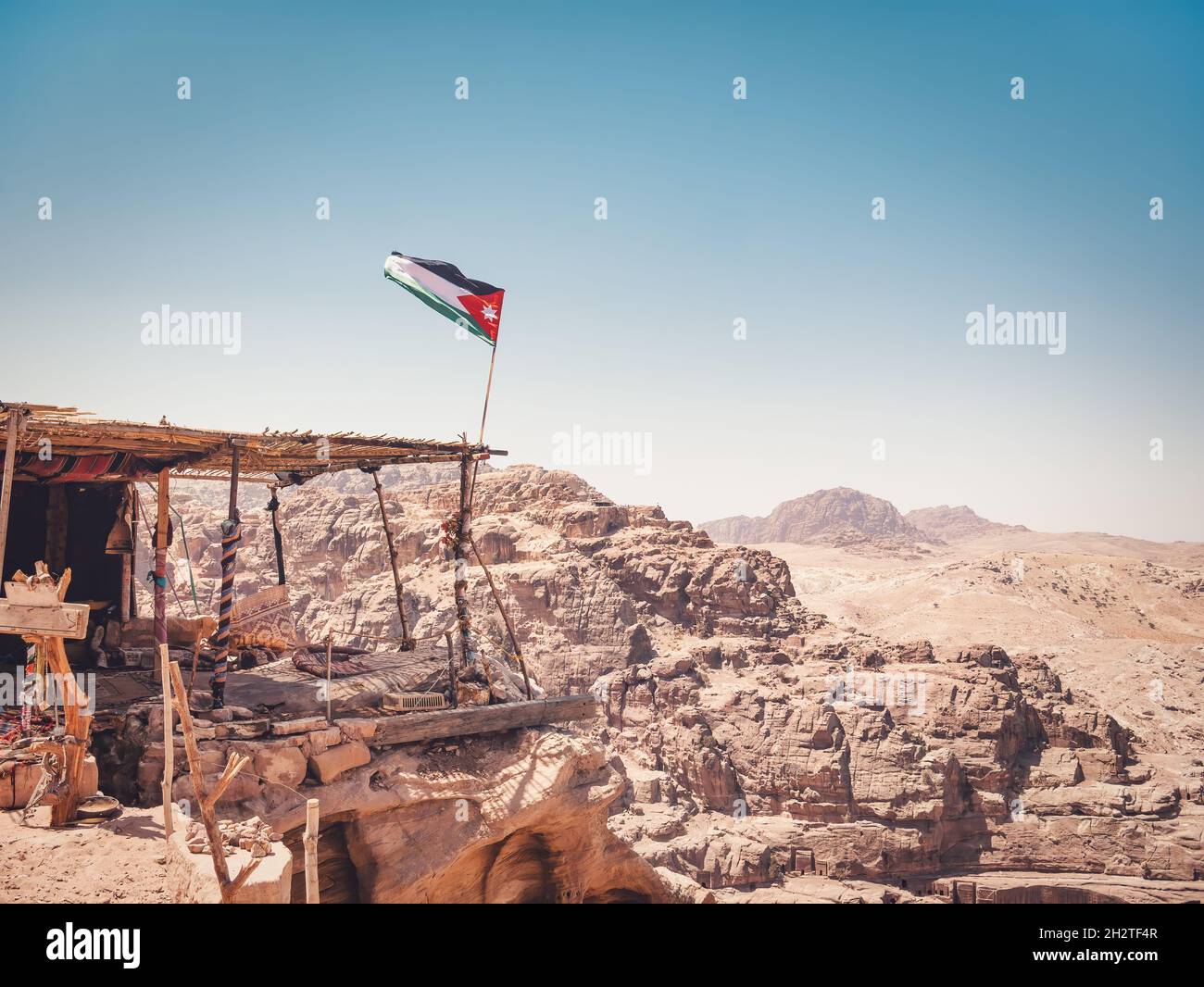 Jordanian flag waving in the wind at a viewpoint in the ancient city of ...