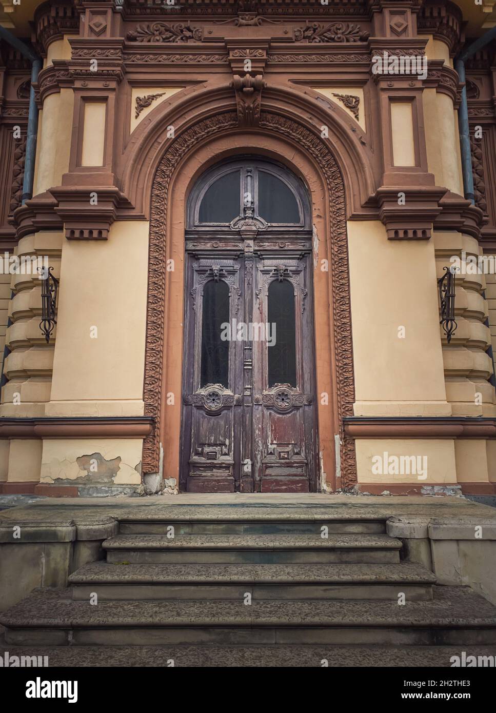 Vintage door and ornate facade details of an old historical building ...