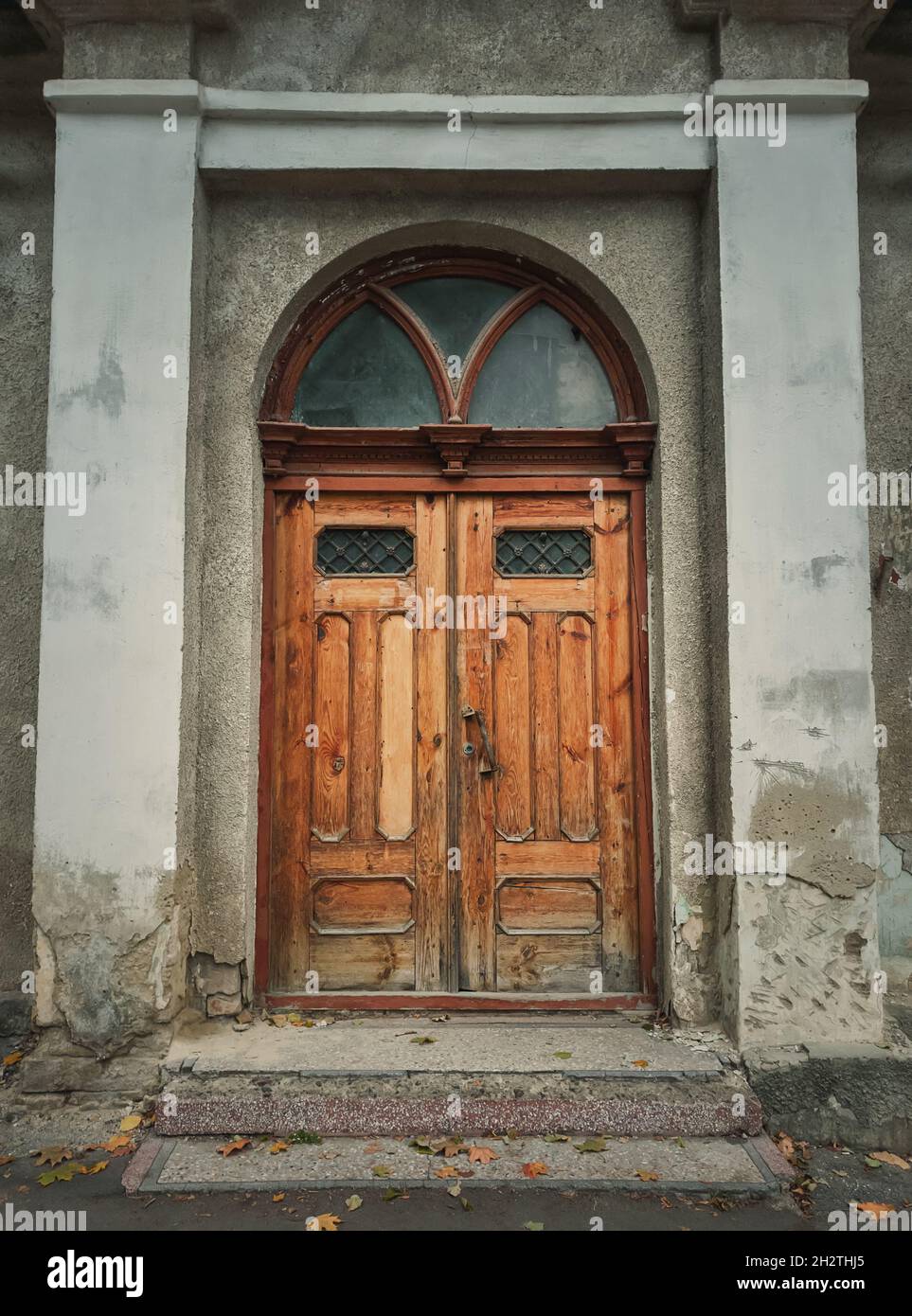 Vintage wooden door and weathered facade details of an old historical ...