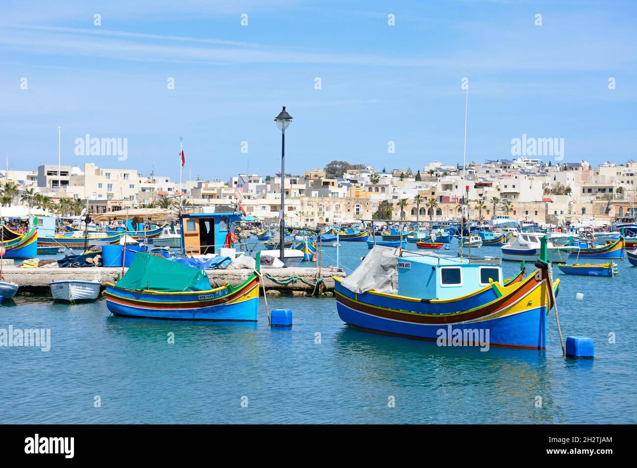 Traditional Maltese Dghajsa fishing boats in the harbour with ...