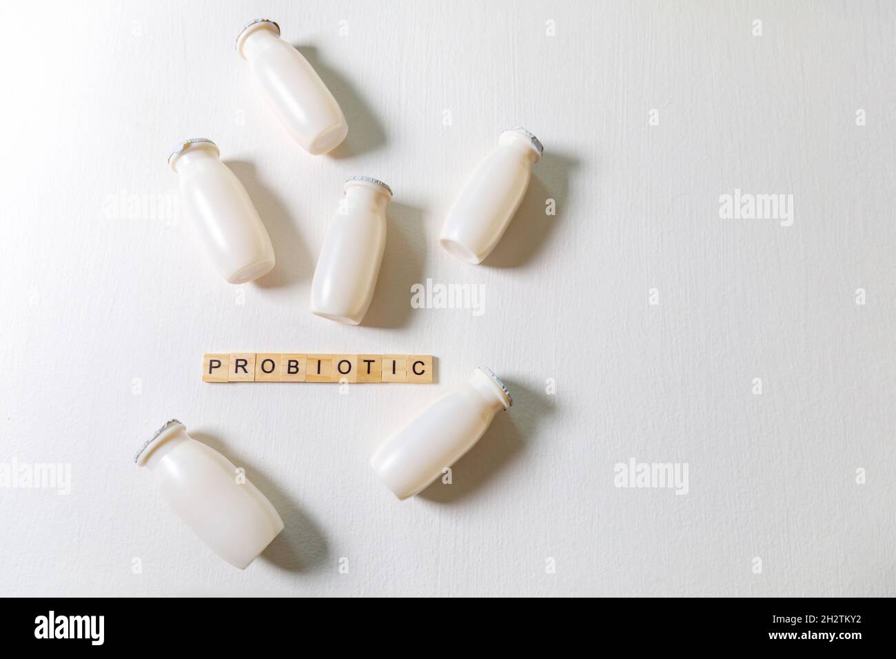 Small bottles with probiotics and prebiotics dairy drink on white ...