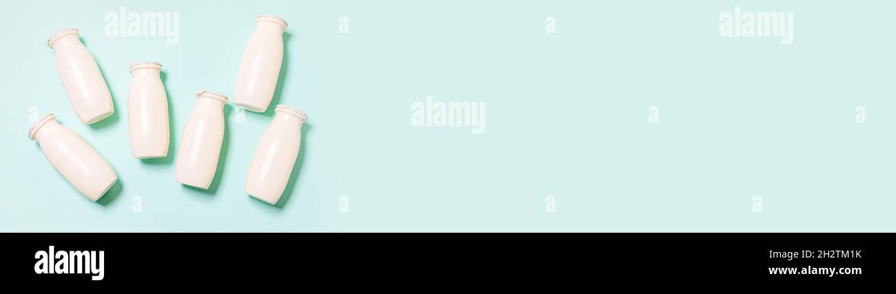 Small bottles with probiotics prebiotics dairy drink on blue background ...