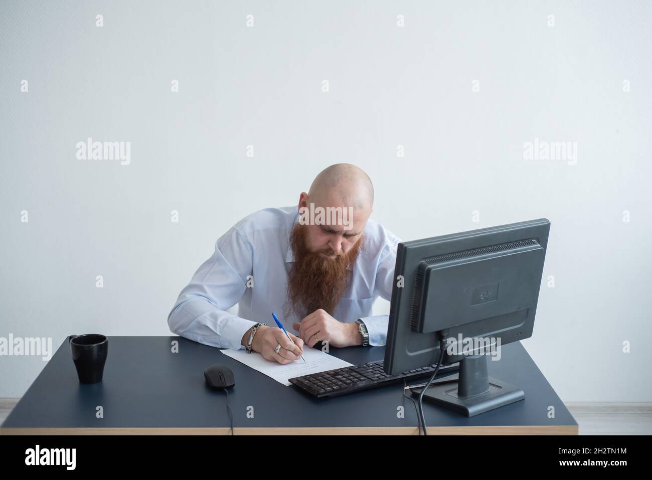 Problems for the office worker. A bald man in a white shirt sits at a ...