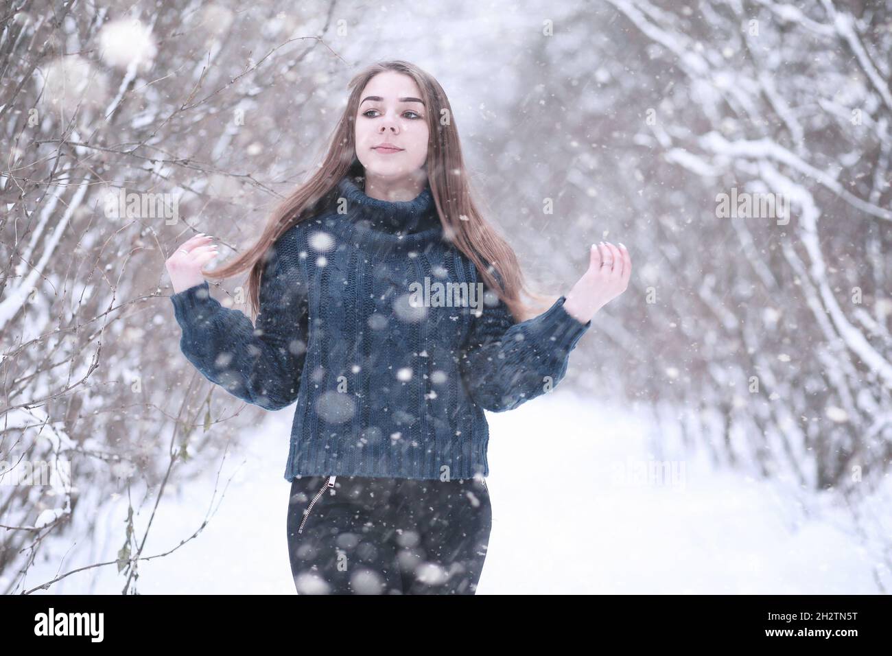 Girl in a winter park in the afternoon in snowfall Stock Photo - Alamy
