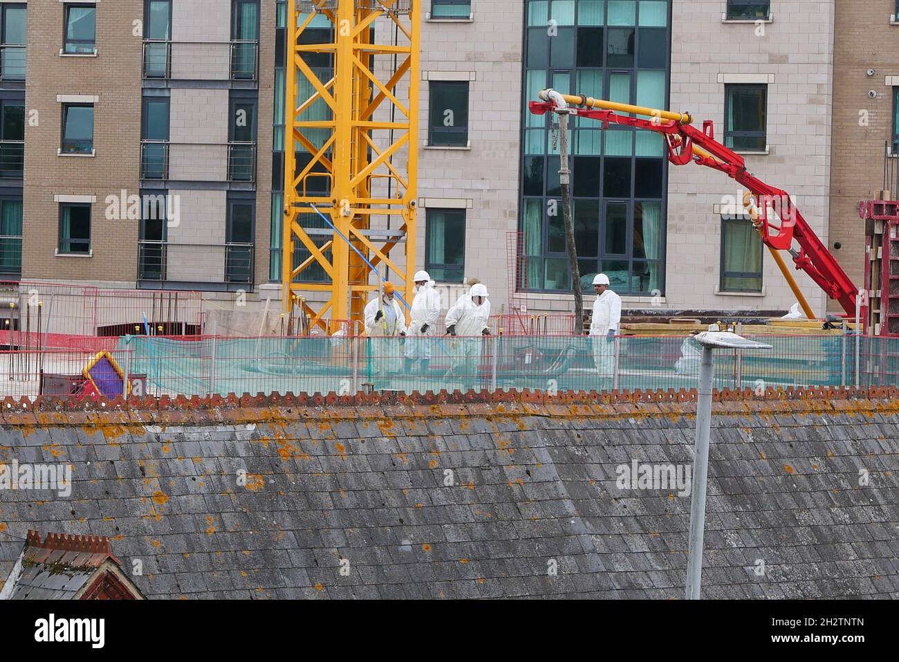 10 September 2021 - Hants, UK: Building site with cranes and workmen ...