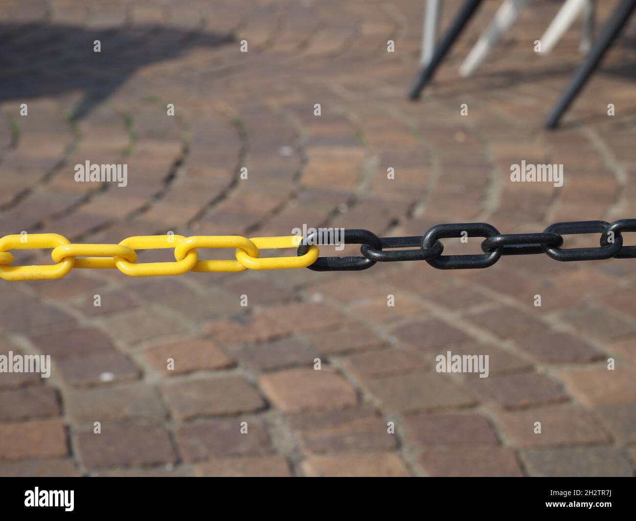 yellow and black plastic chain, focus on foreground and blurred ...