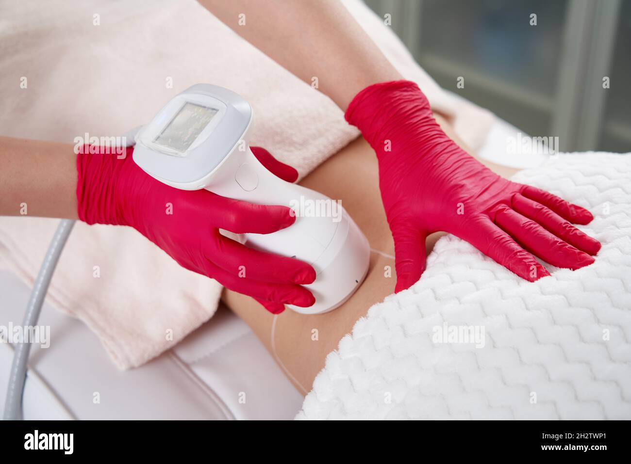 Young woman getting fat reductive skin lifting body treatment by a ...